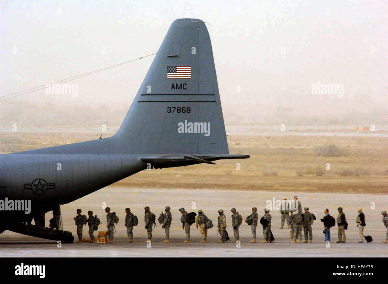 Personnel supporting Operation Iraqi Freedom load onto a C-130 Hercules ...