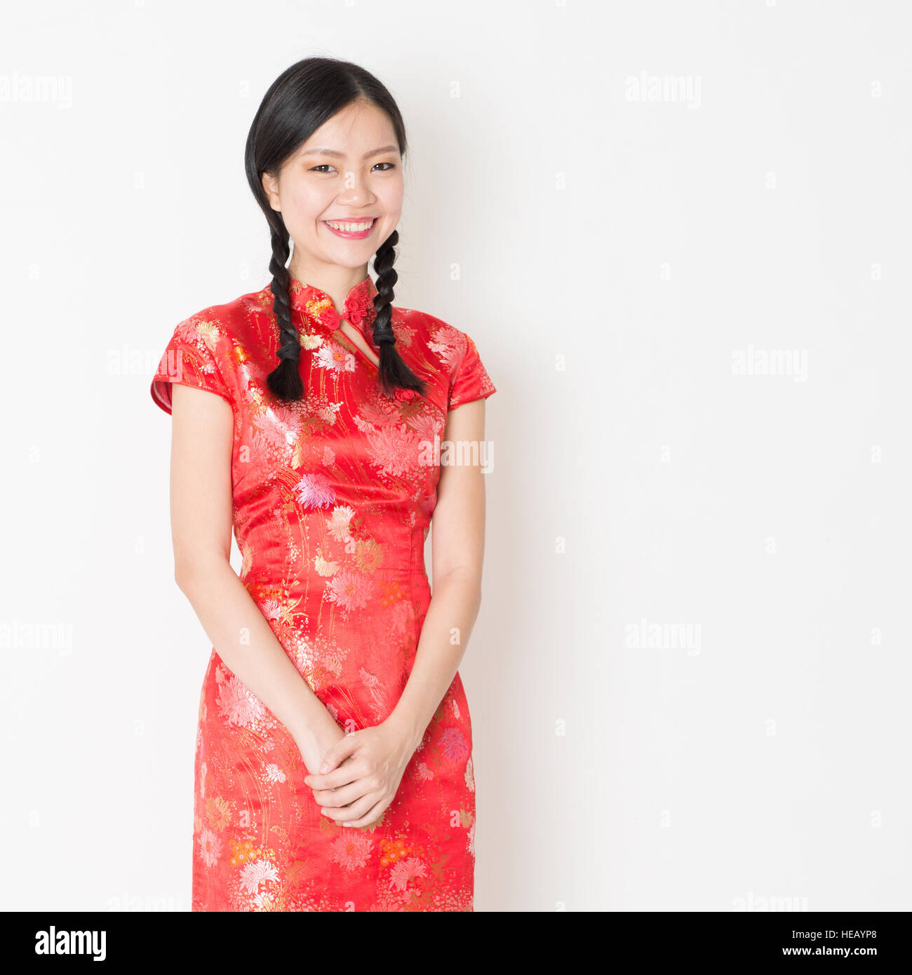 Portrait of young Asian woman in traditional qipao dress smiling ...