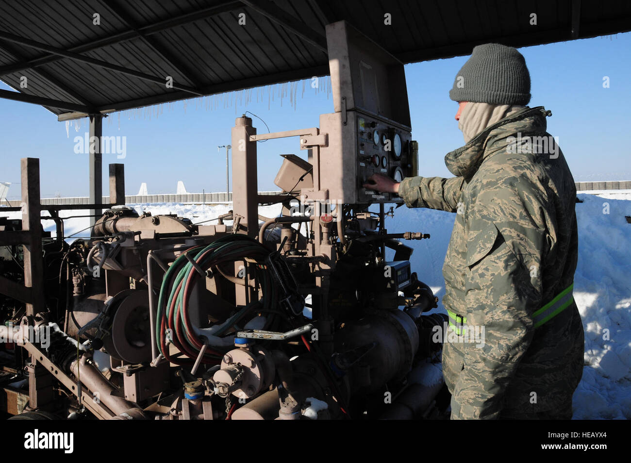 Airman 1st Class Justin Bell, pumps jet fuel into a tank to be ...