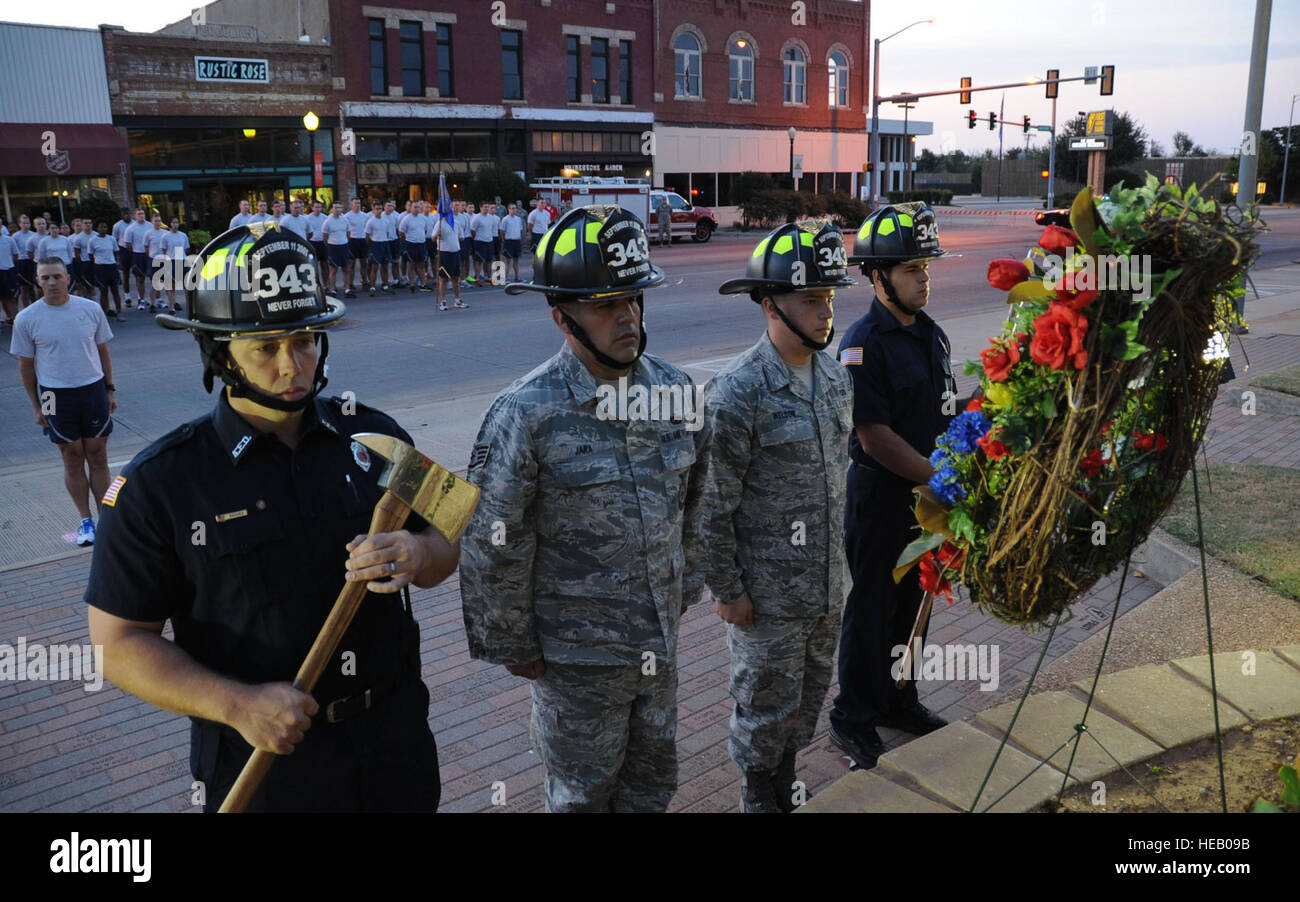 Members of the military and local emergency responders stand at ...