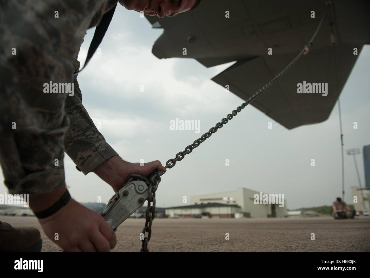 A 19th Aircraft Maintenance Squadron member attaches a chain to a C-130 ...