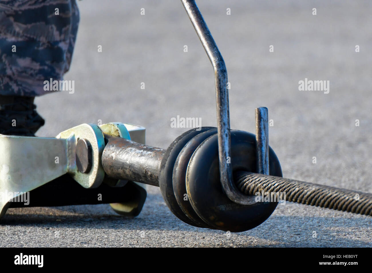 A 51st Civil Engineer Squadron Airman adjusts the placement of a cable ...