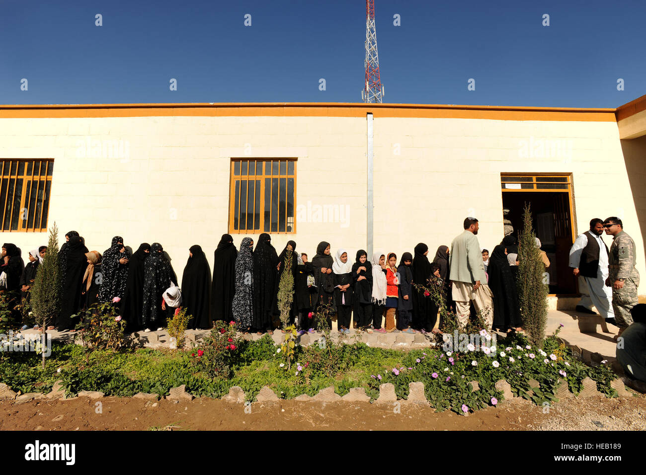 The 60 girls who attend the Farah City Orphanage line up outside the ...