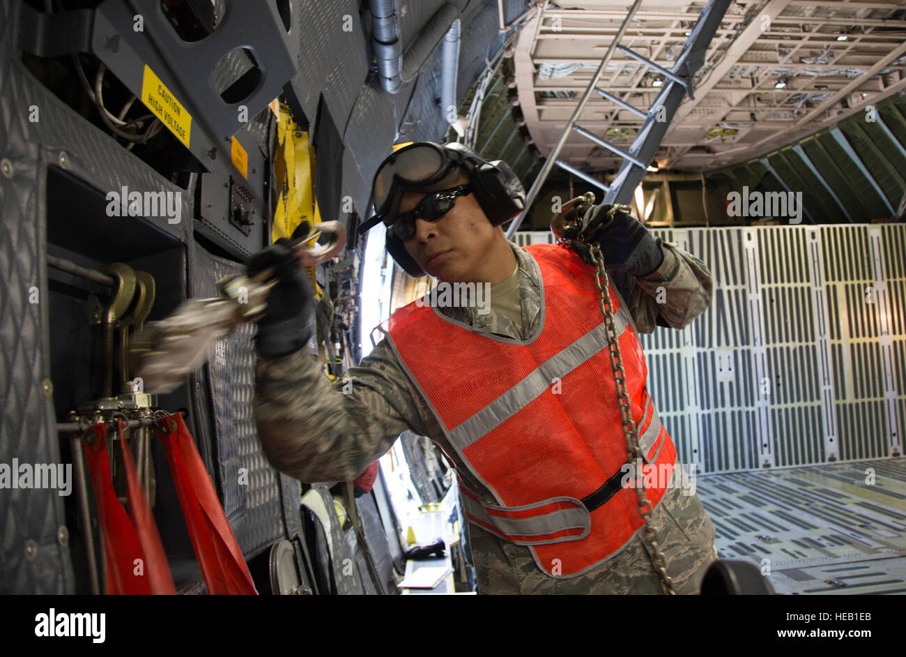 Air Mobility Wing, Airlift Squadron, and Coast Guard personnel load and ...