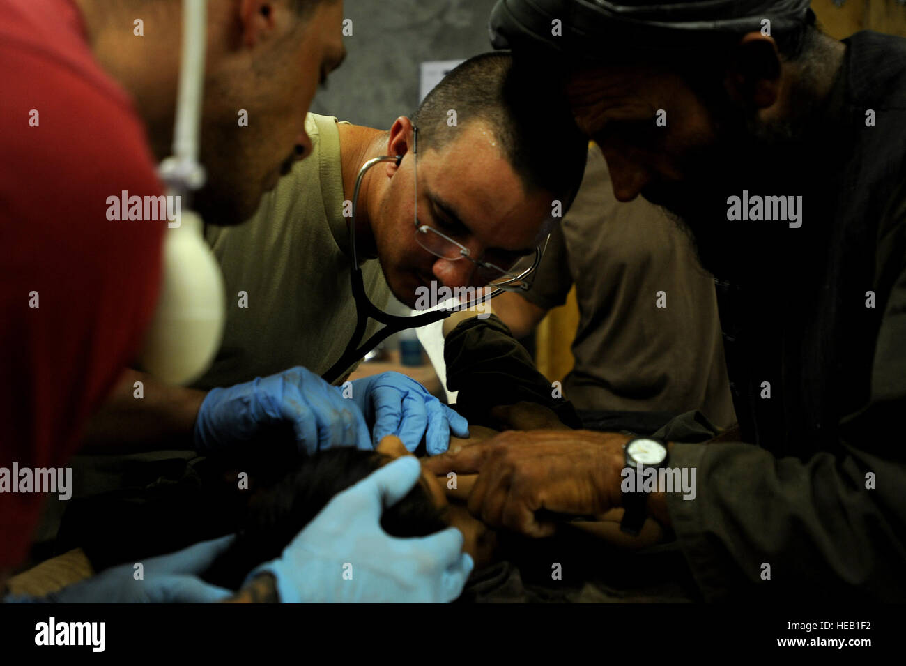 A U.S. Army combat medic treats an injured child at Forward Operating ...
