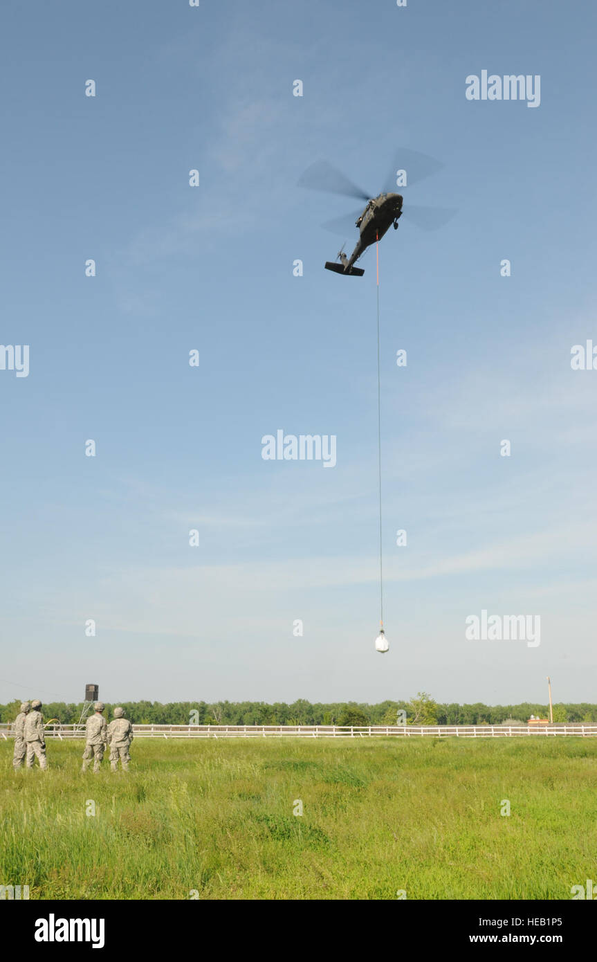 North Dakota National Guard UH-60 Black Hawk helicopters hover while ...