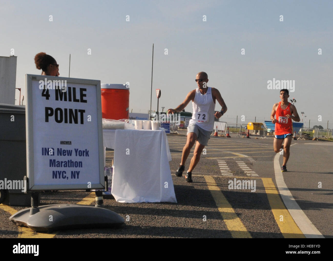 A participant reaches for water at the 4-mile mark during the 4th ...