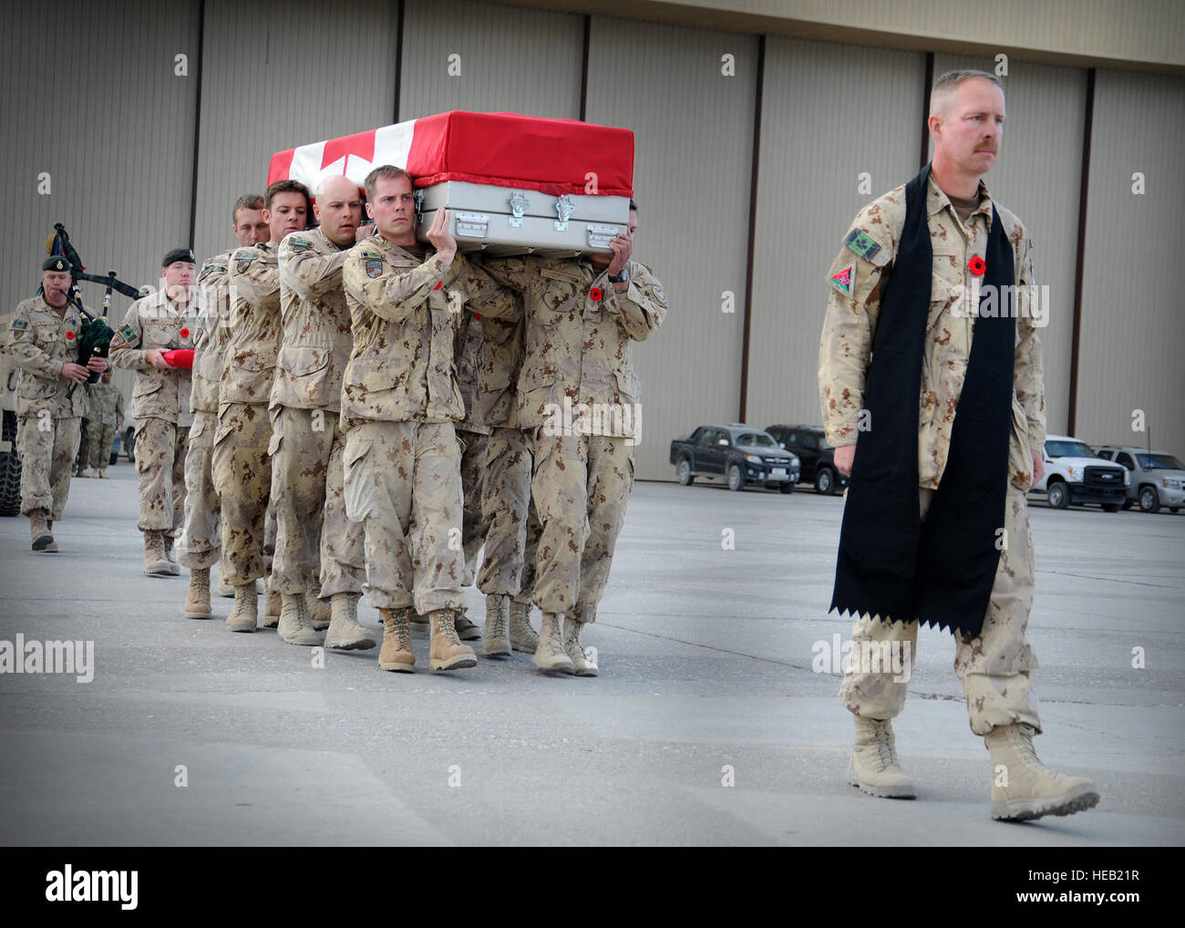 A cadre of Canadian service members, led by a chaplain, carry the ...