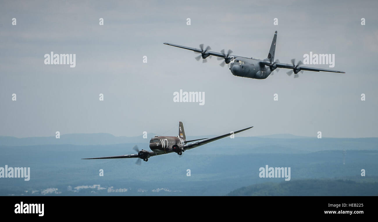 A Douglas C-47 Skytrain, known as Whiskey 7, flies alongside a C-130J ...