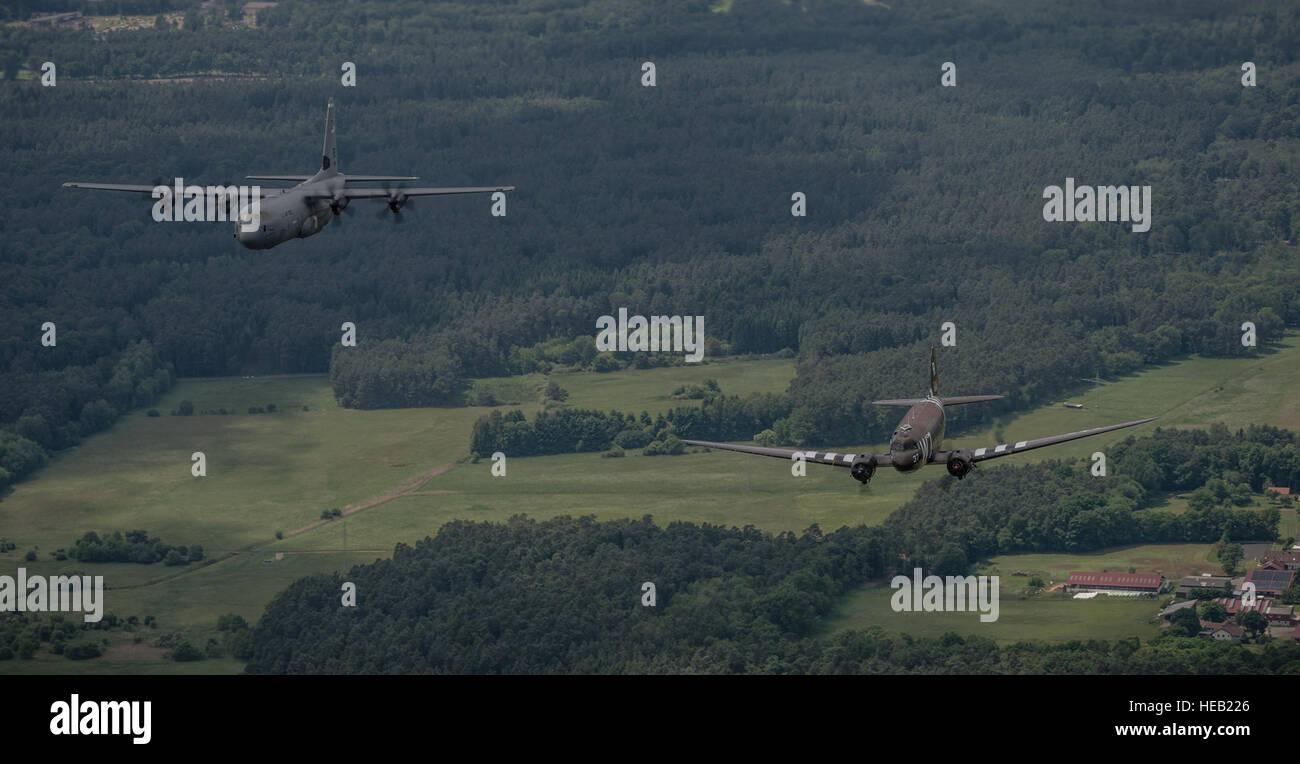 A Douglas C-47 Skytrain, known as Whiskey 7, flies alongside a C-130J ...