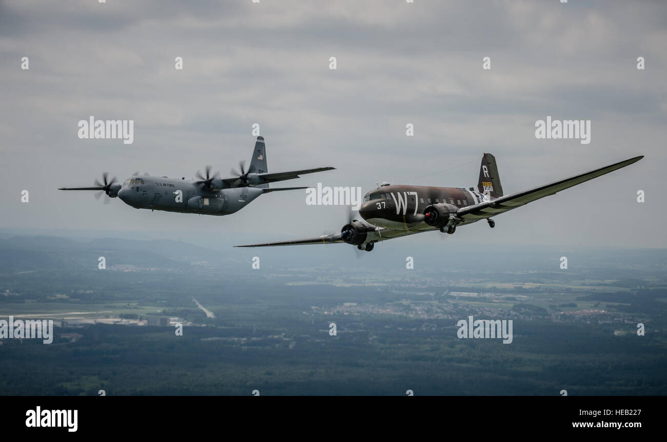 A Douglas C-47 Skytrain, known as Whiskey 7, flies alongside a C-130J ...