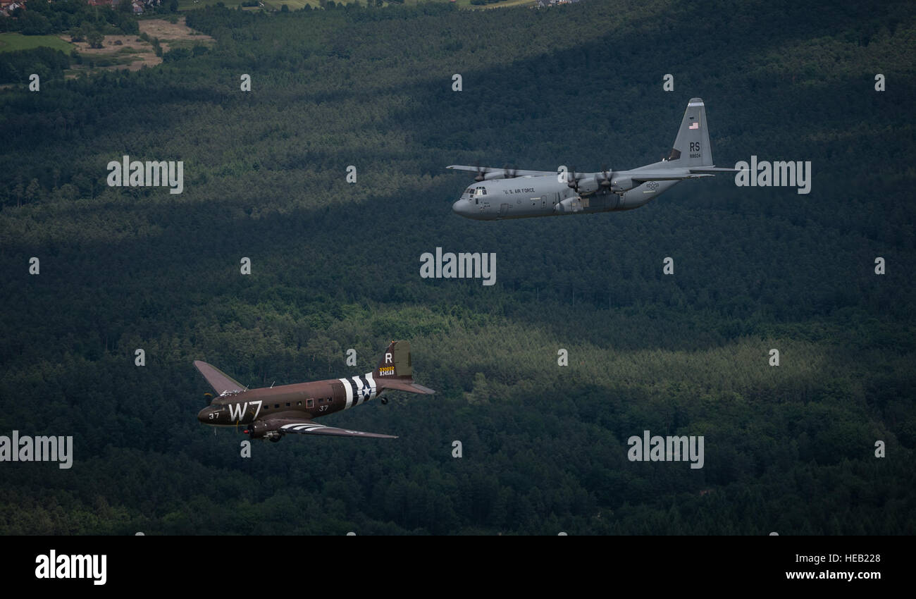 A Douglas C-47 Skytrain, known as Whiskey 7, flies alongside a C-130J ...
