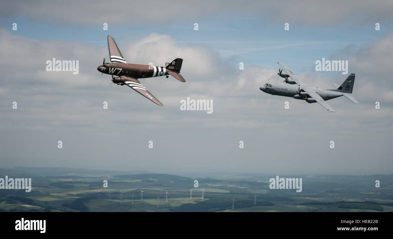 A Douglas C-47 Skytrain, known as Whiskey 7, flies alongside a C-130J ...