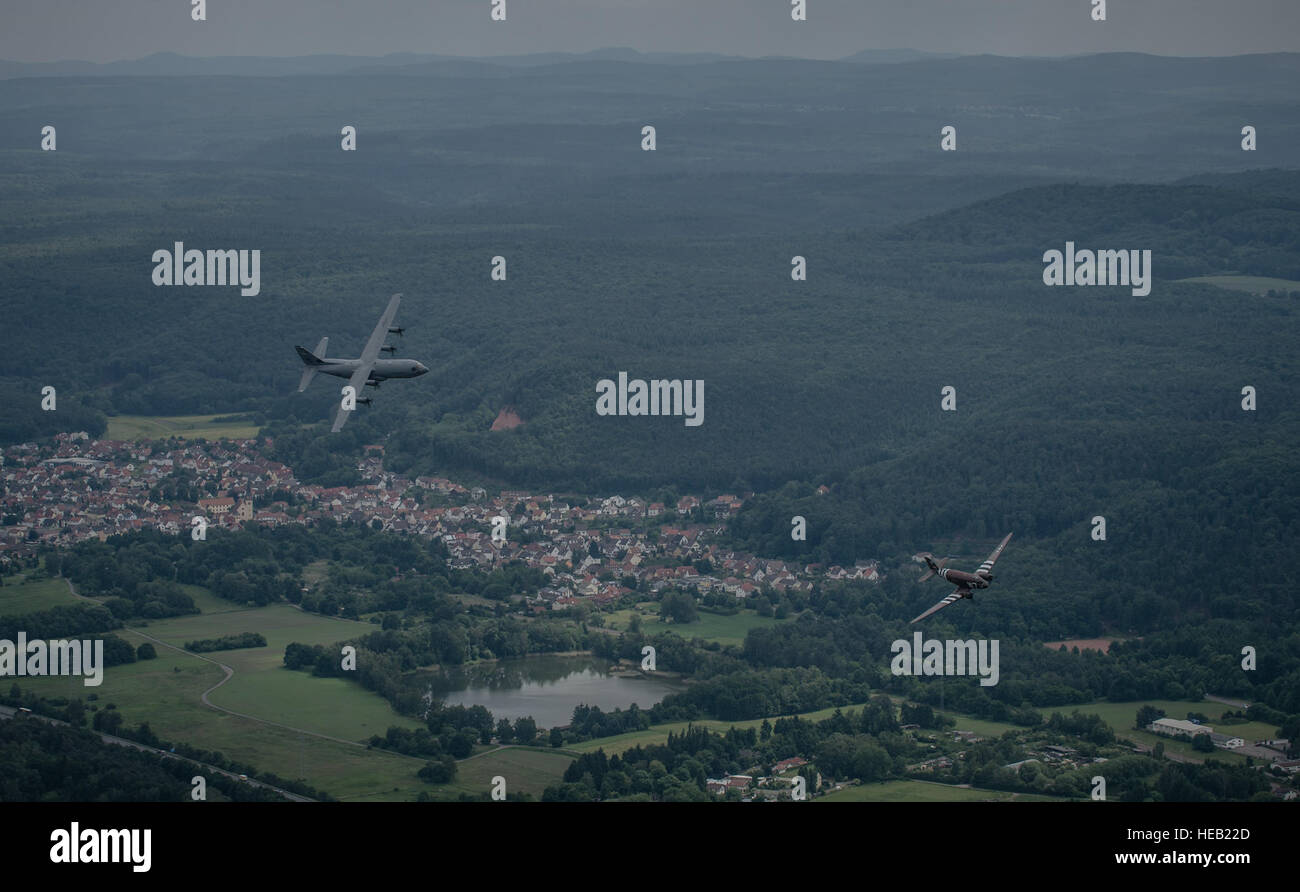 A Douglas C-47 Skytrain, known as Whiskey 7, flies alongside a C-130J ...