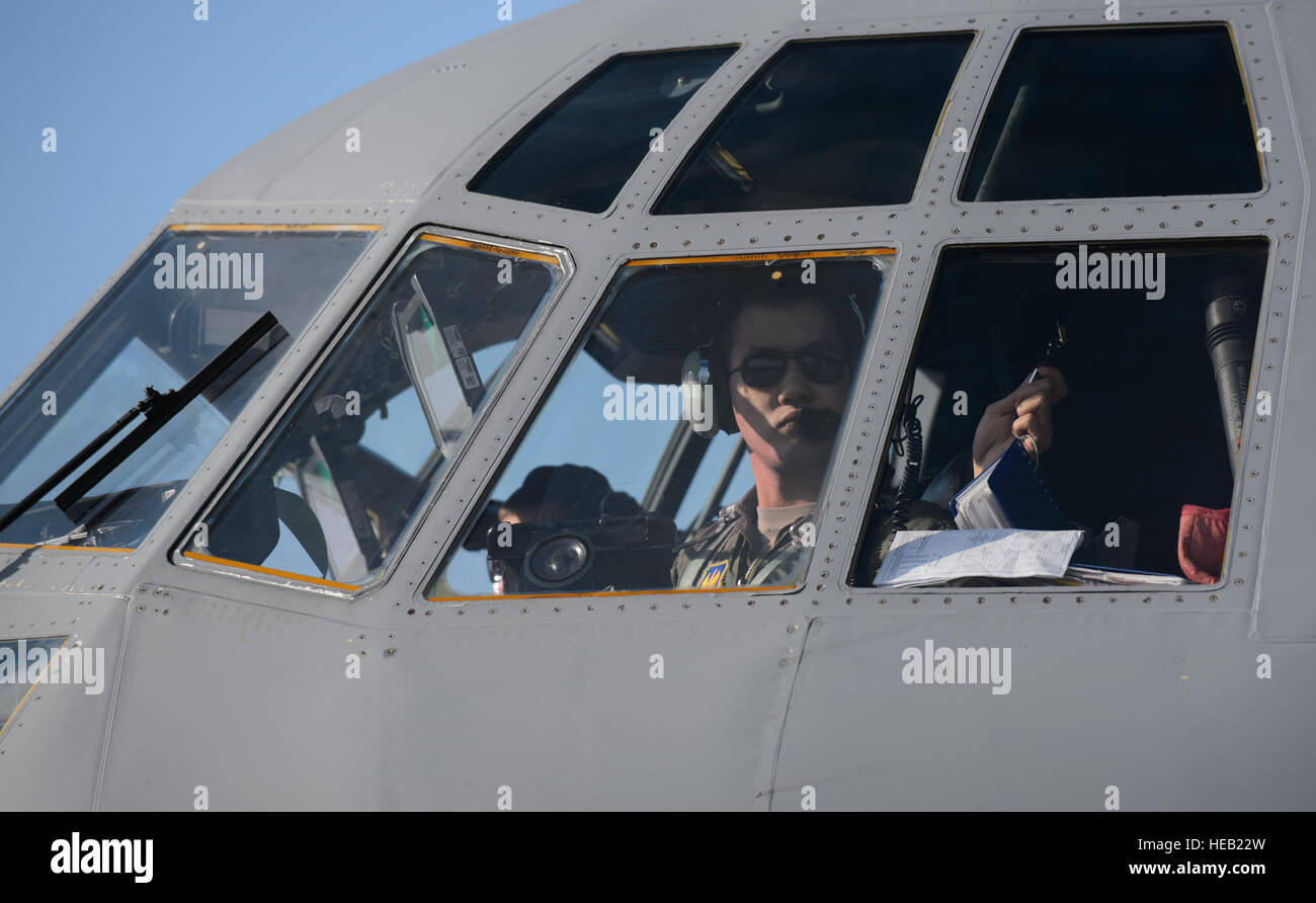 Capt. Isaac Leung, 37th Airlift Squadron pilot, grabs his checklist as ...