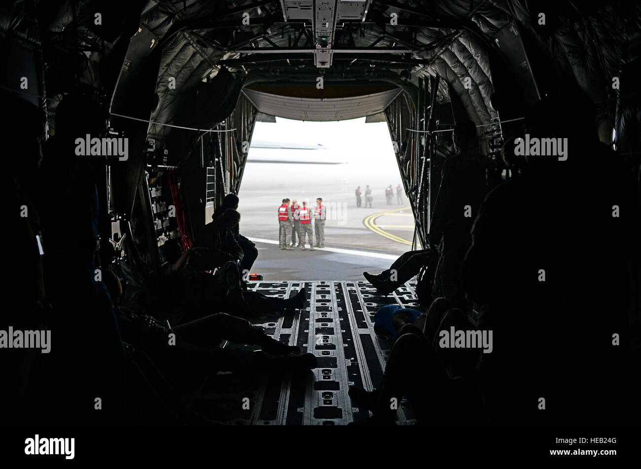 A group of wing inspection team members gather outside a C-130J Super ...