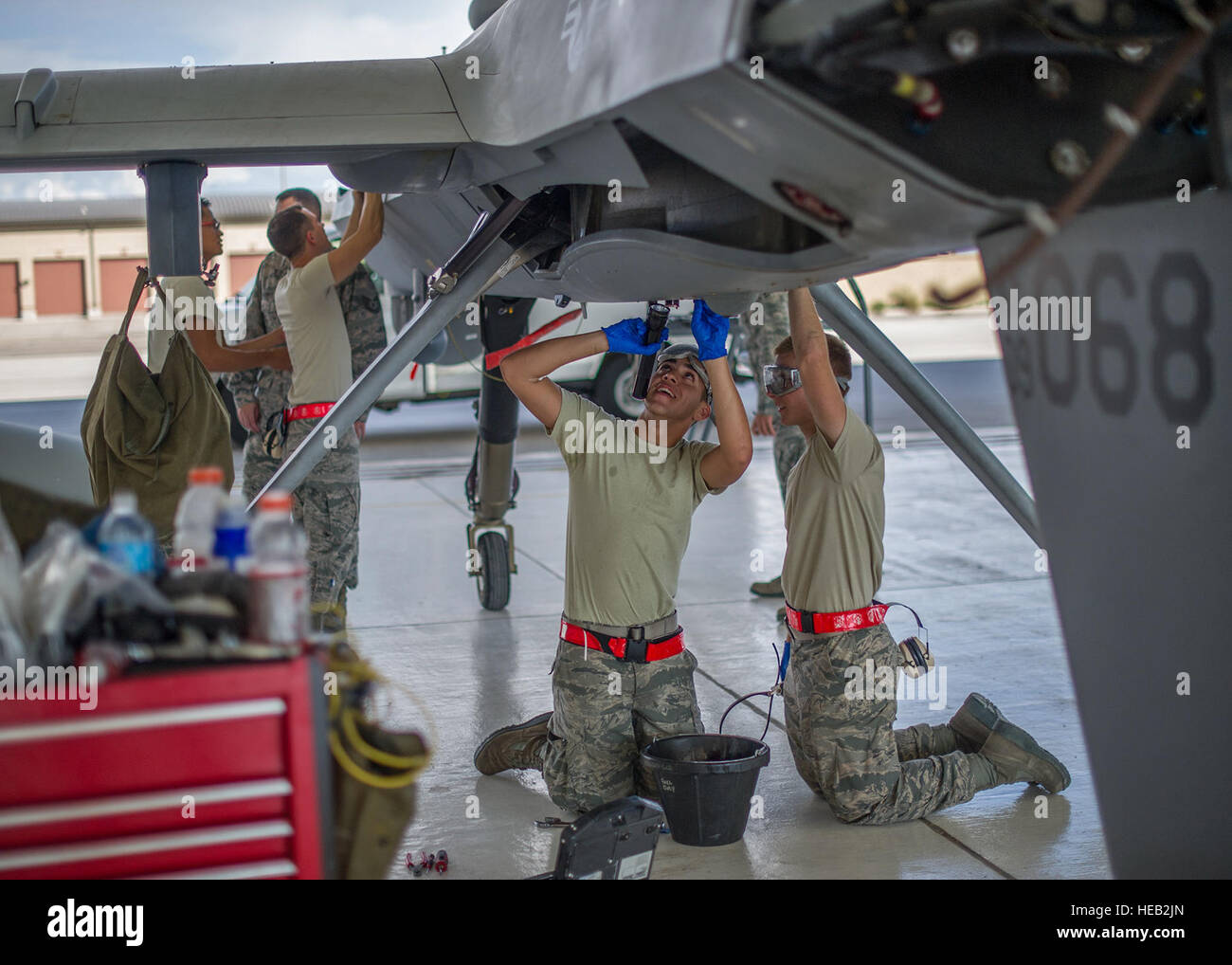 MQ-9 Reaper crew chiefs perform a routine inspection Aug. 12, 2014, on ...