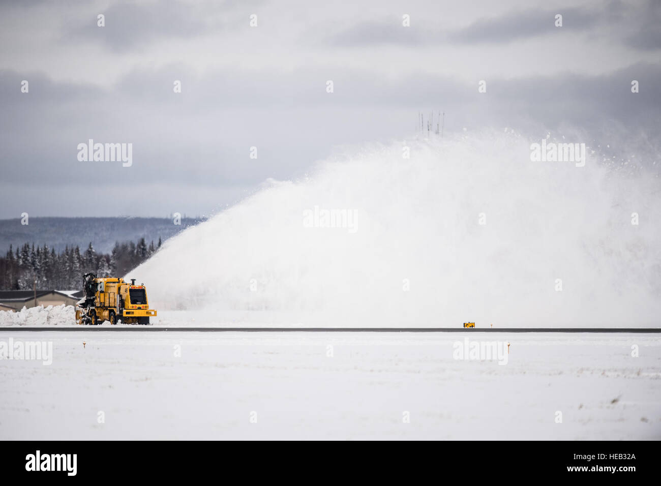 A 354th Civil Engineer Squadron snow broom clears a runway of snow and ...