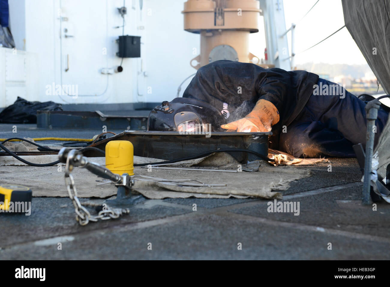 Petty Officer 2nd Class Johnathan Mijares, a damage controlman assigned ...