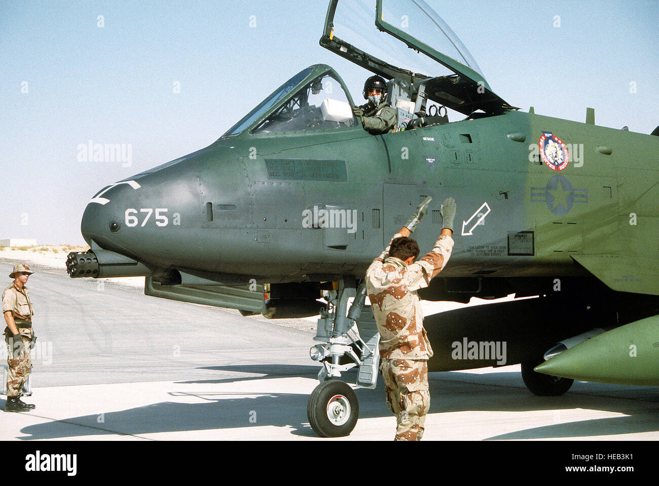 A ground crewman signals as the pilot of a 353rd Tactical Fighter ...