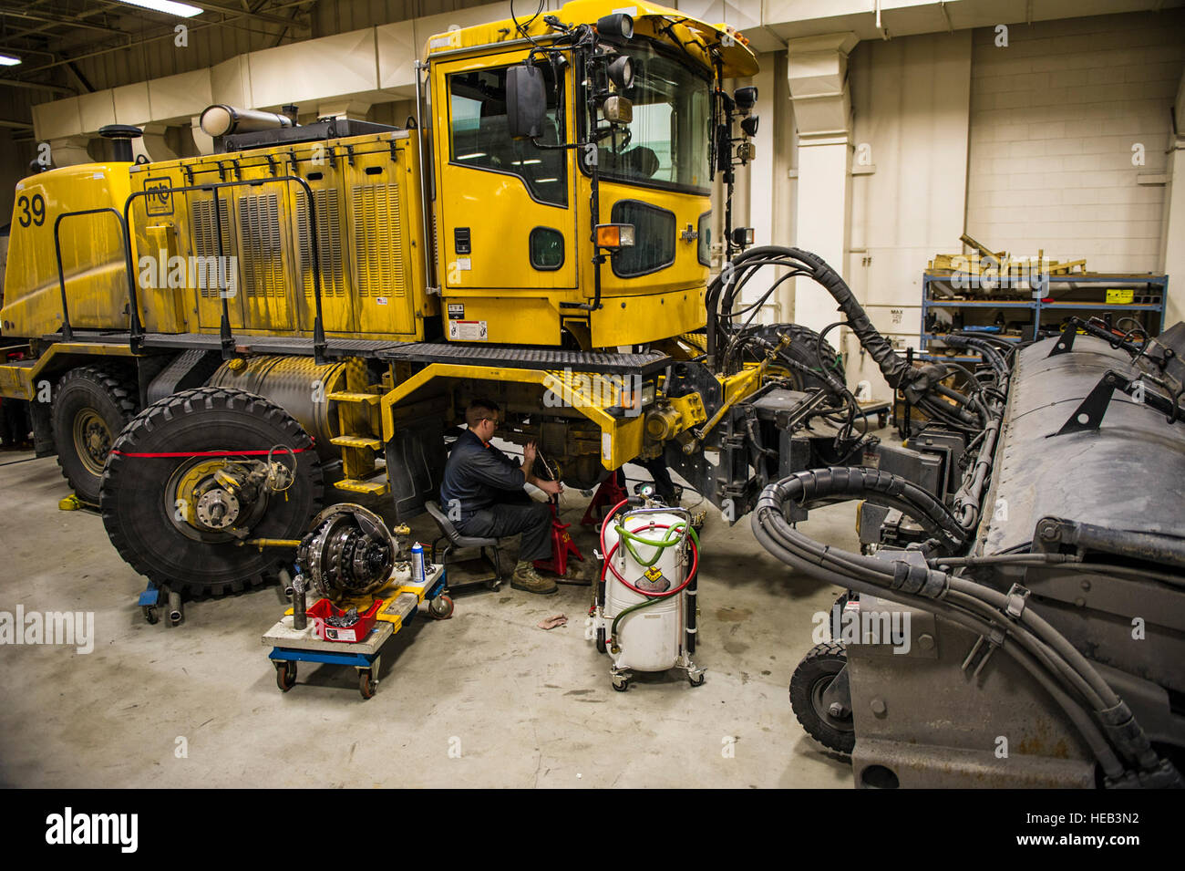 Senior Airman Anthony Tavares cleans the front axle housing of a ...