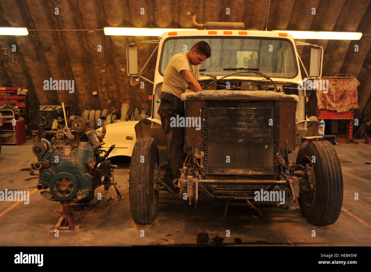 Airman 1st Class Scott Middlebrooks connects the lower radiator hose to ...