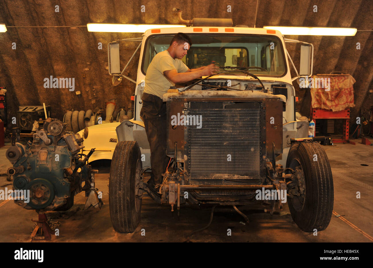 Airman 1st Class Scott Middlebrooks connect the upper radiator hose to ...
