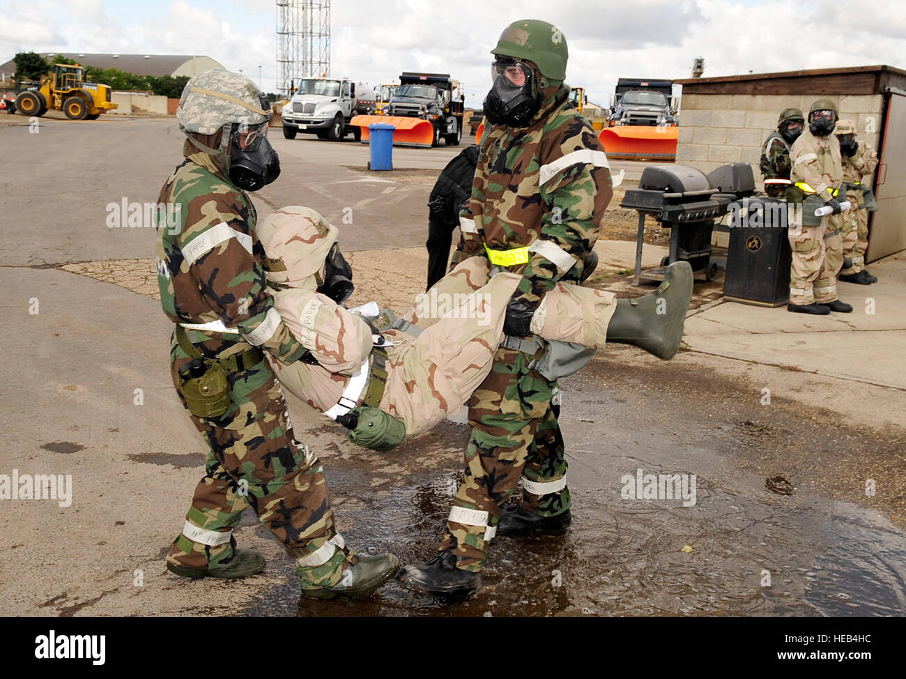Airmen from the 100th Civil Engineer Squadron carry a simulated injured ...