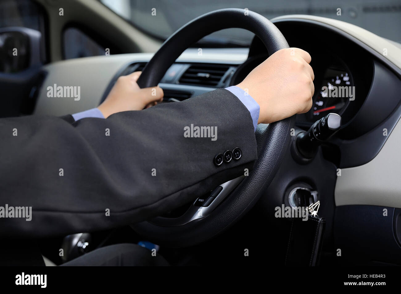 Business man wearing business suit driving a car Stock Photo - Alamy
