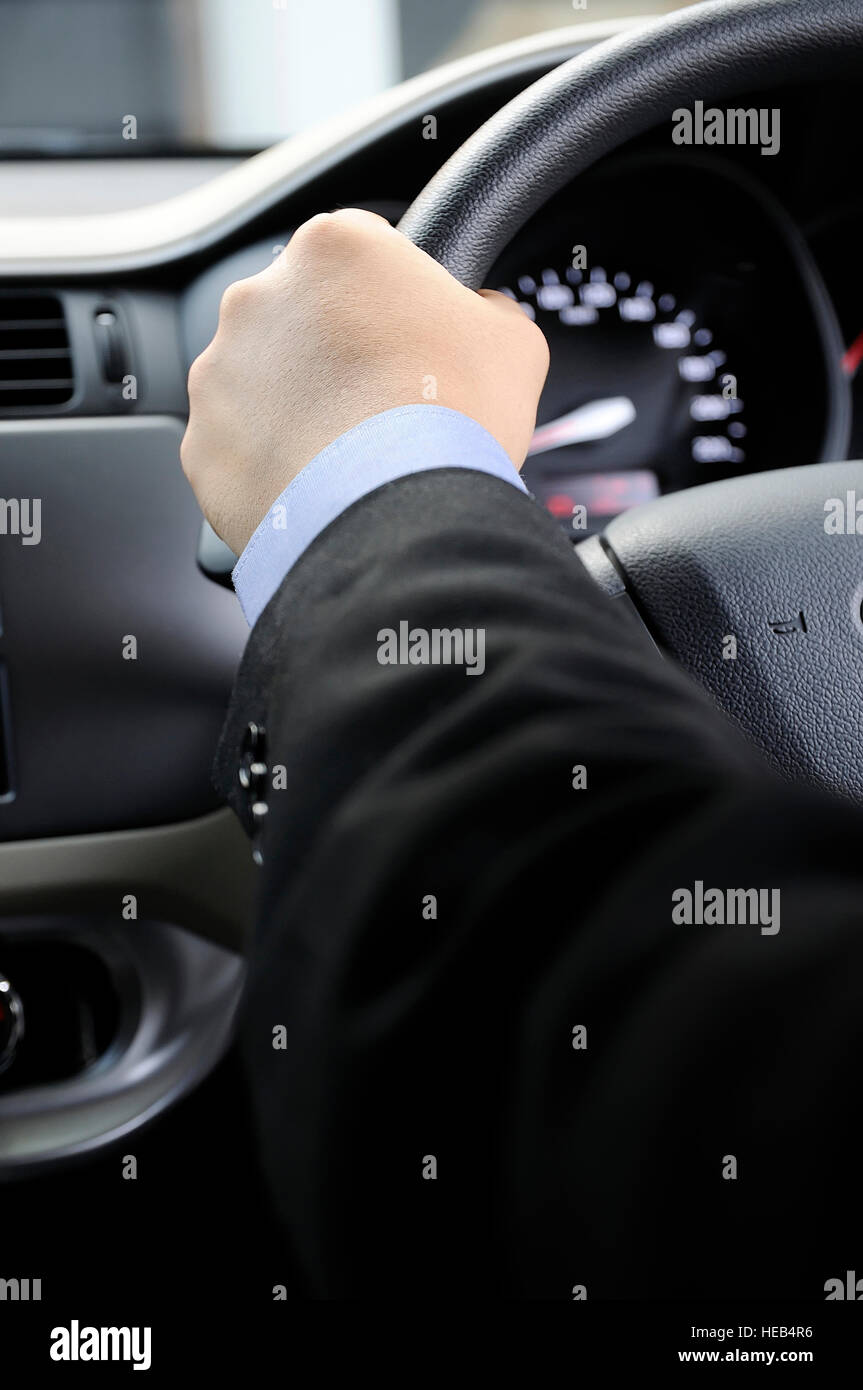 Business man wearing business suit driving a car Stock Photo - Alamy