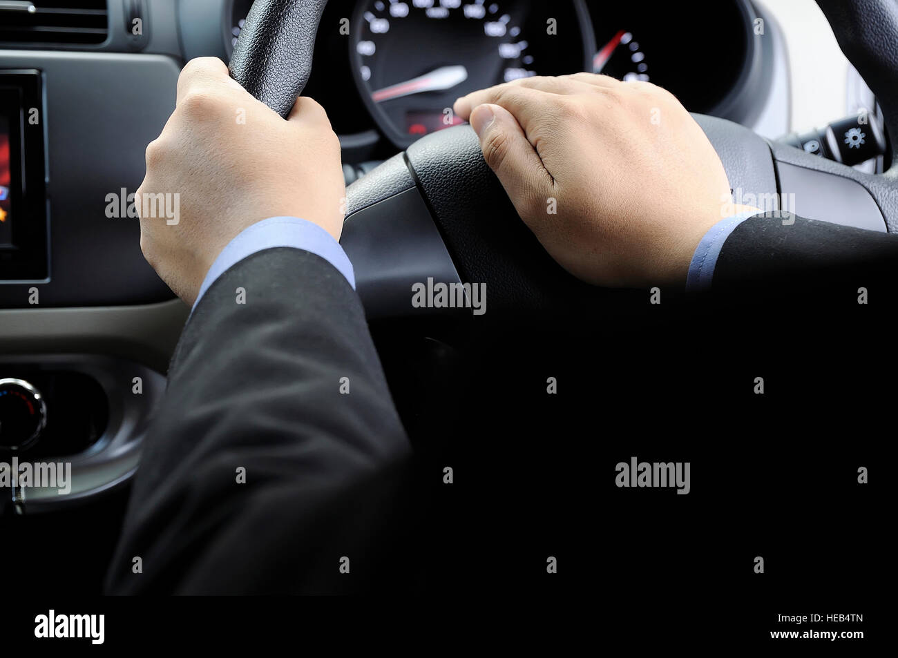 Business man wearing business suit driving a car Stock Photo - Alamy
