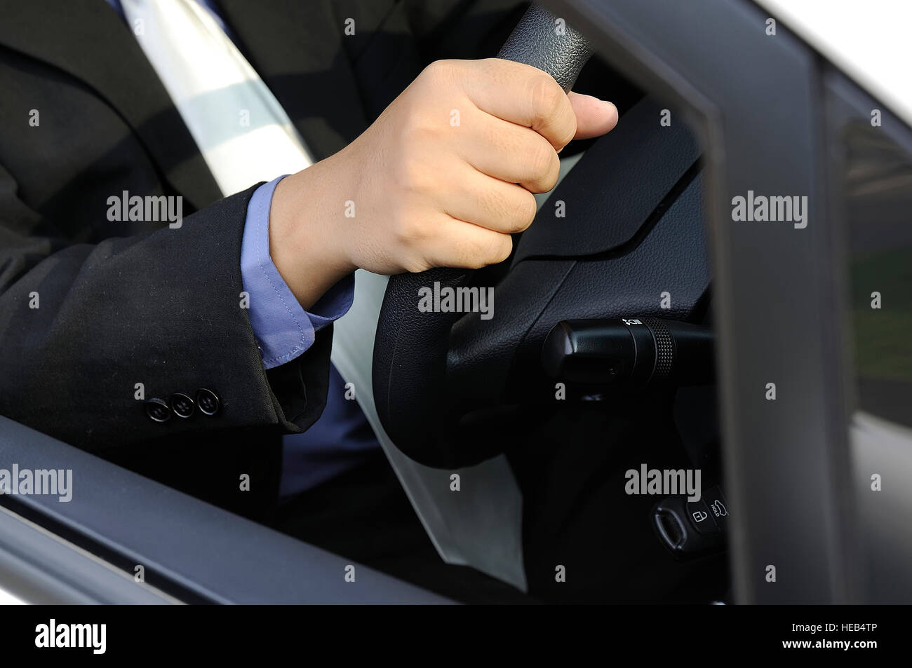 Business man wearing business suit driving a car Stock Photo - Alamy