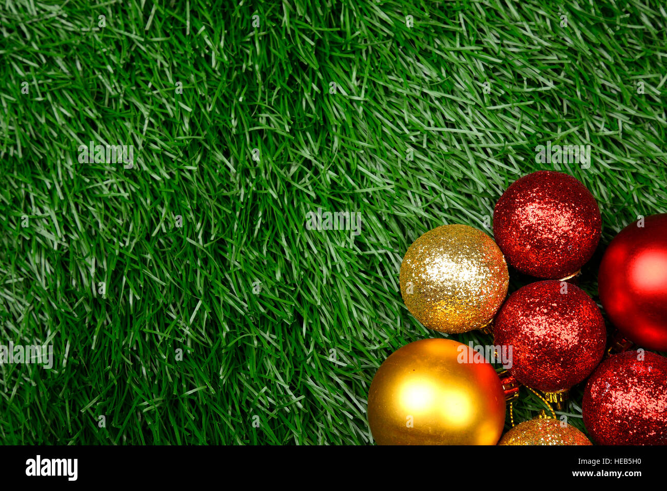 Christmas ornament on the green grass background. Chrismas background ...