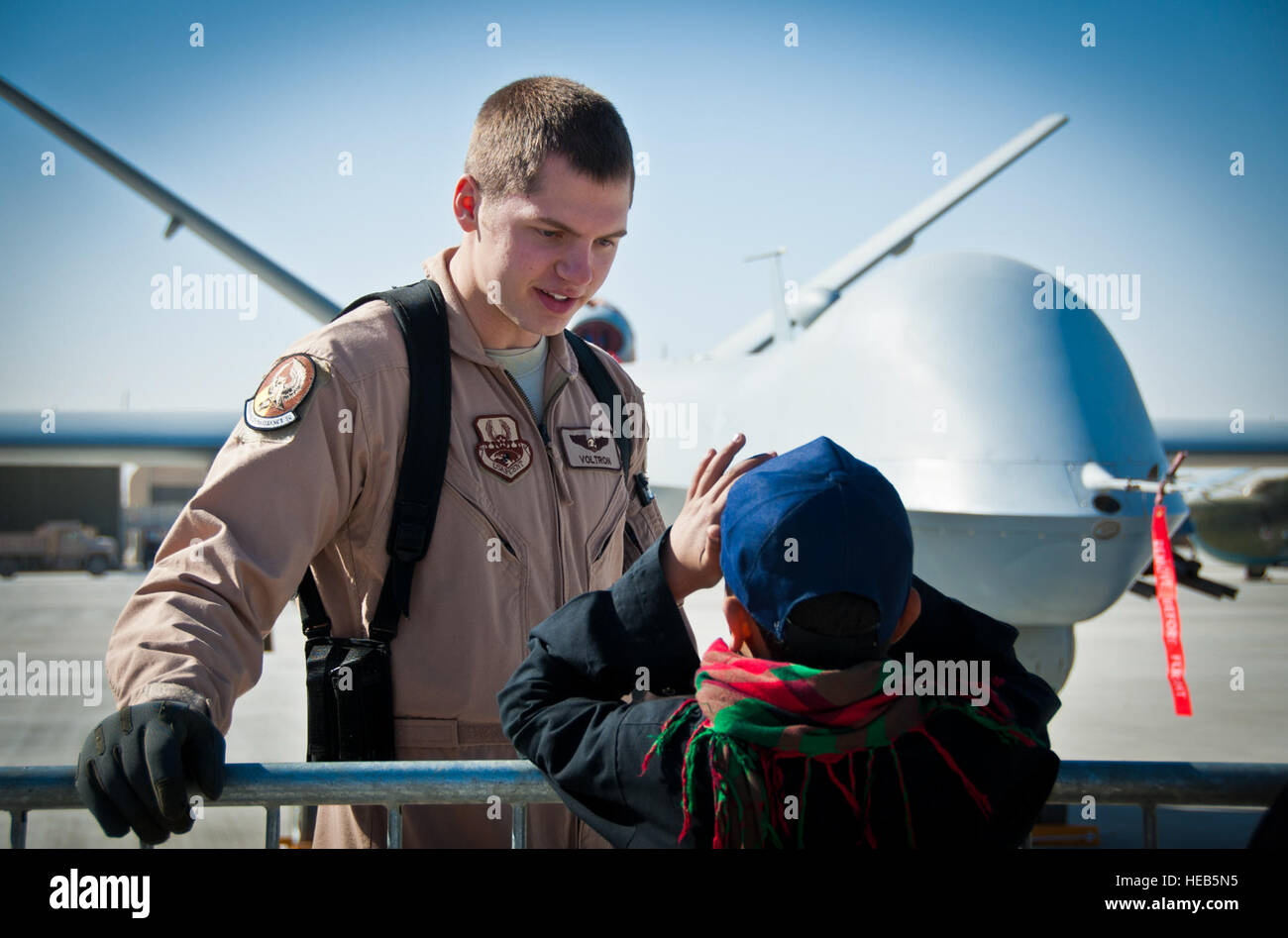 A 62nd Expeditionary Reconnaissance Squadron sensor operator speaks to ...