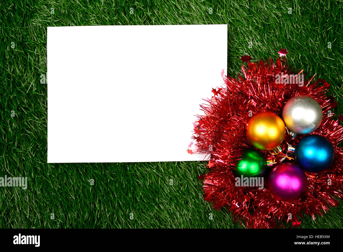 Christmas ball on the green grass background. Chrismas background ...