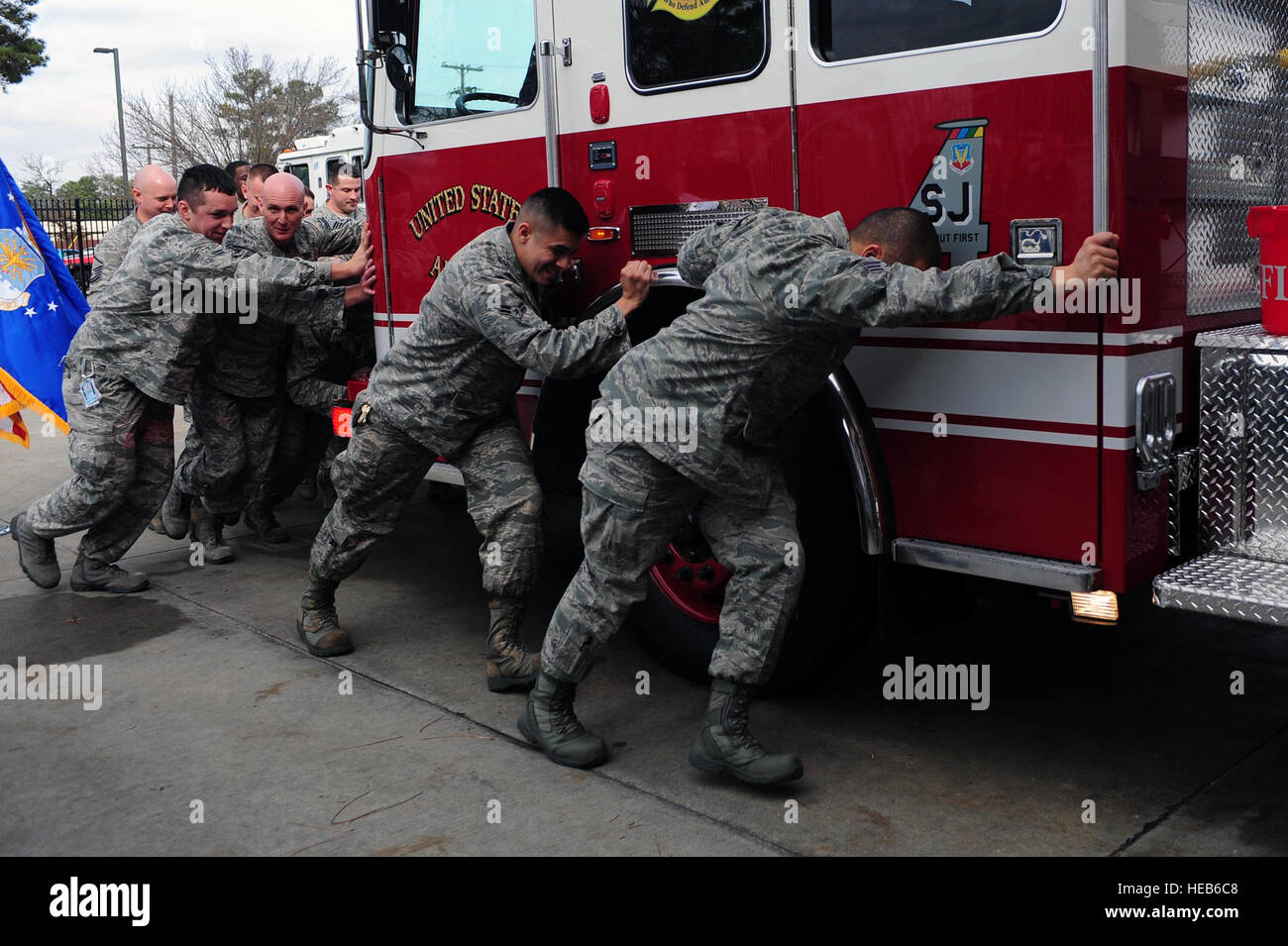 Fire fighters from the 4th Civil Engineer Squadron push Engine Four ...