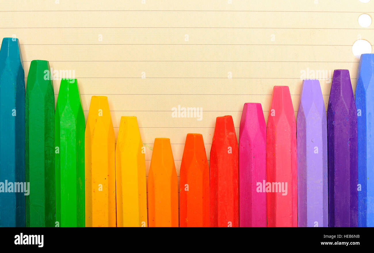 Row of colorful crayon over stripe patern paper Stock Photo - Alamy
