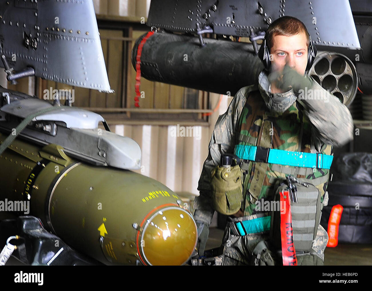 A weapons loading team from the 25th Fighter Squadron, loads bombs on ...