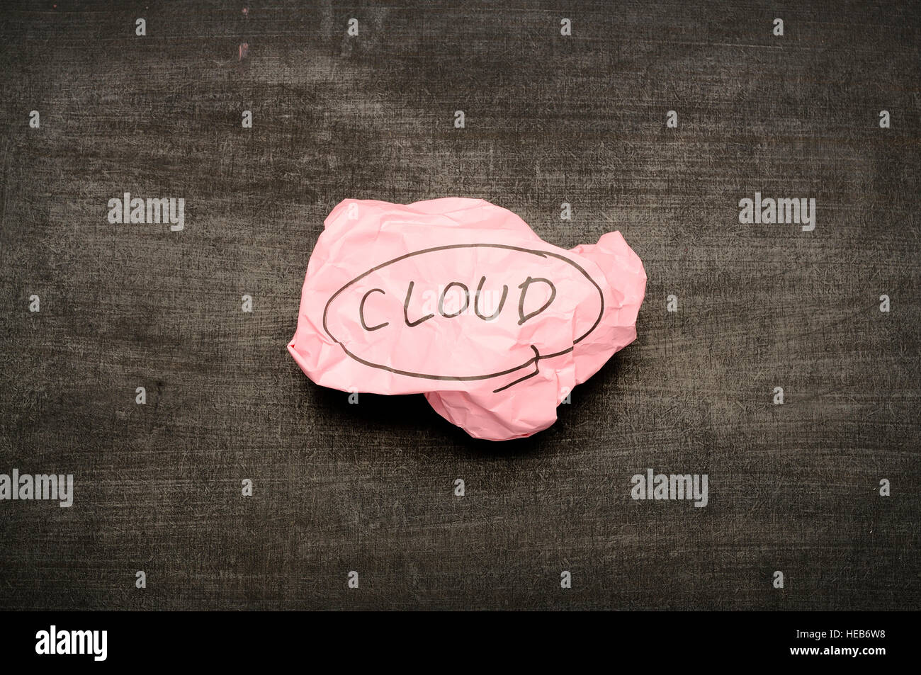 Cloud computing concept. Cloud writing on crumpled paper on blackboard ...