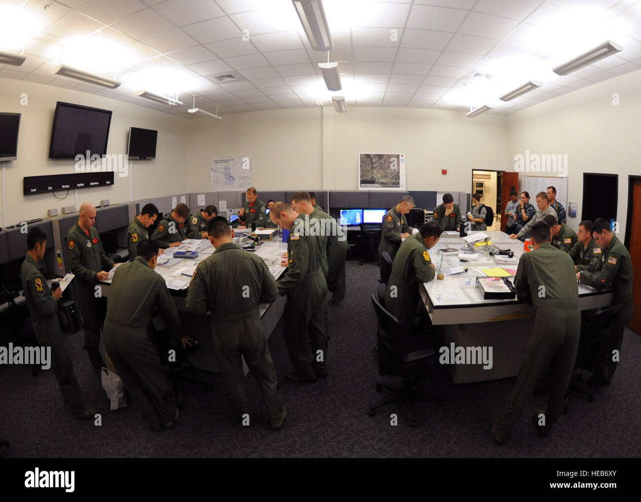 Aircrew from the 535th Airlift Squadron conduct a pre-mission briefing ...