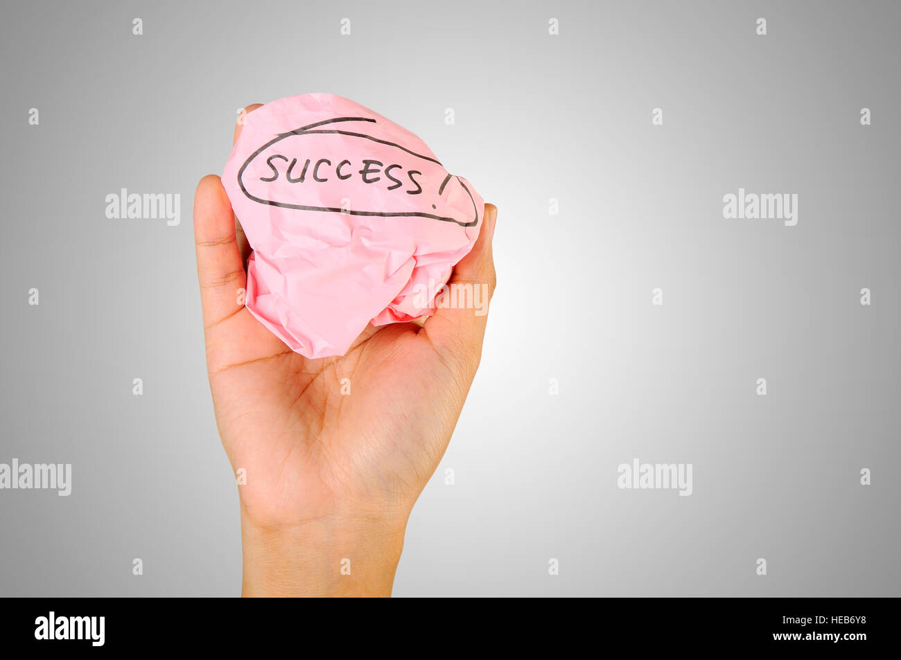 Success Concept. Human hand holding crumpled paper with success writing ...