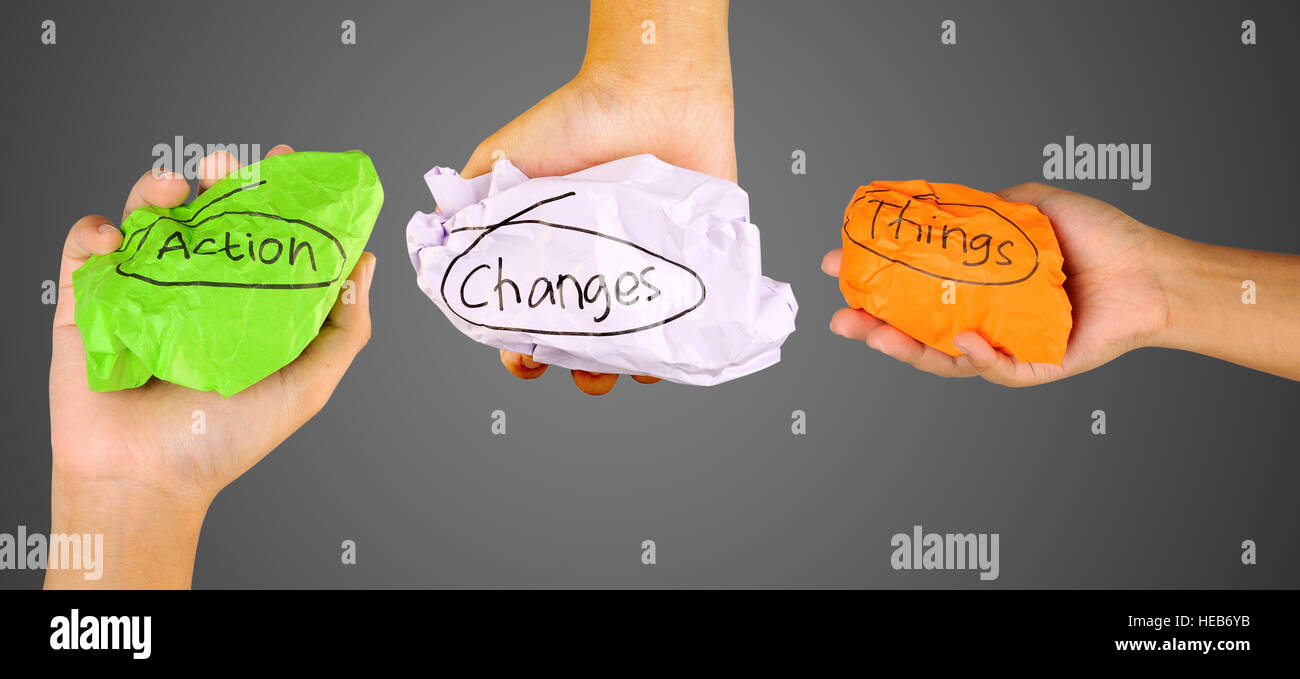 Action Changes Things concept. Human hands holding crumpled paper with ...
