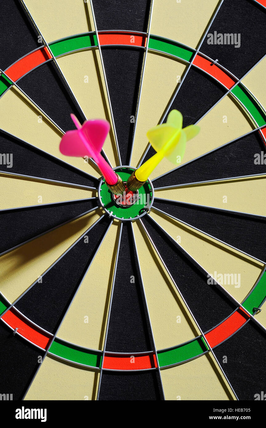 Dart arrows in the target center of dart game Stock Photo - Alamy
