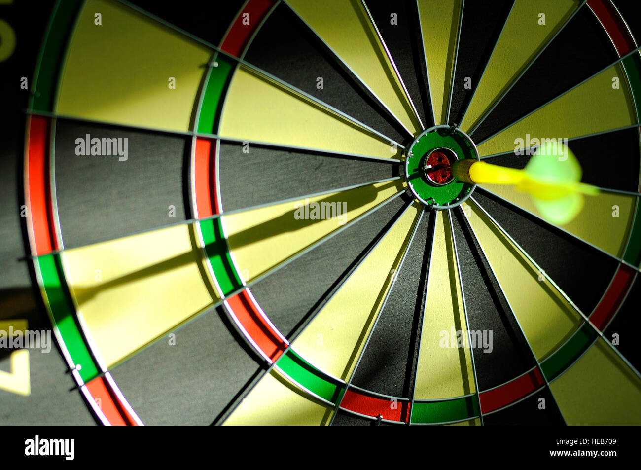 Dart arrows in the target center of dart game Stock Photo - Alamy