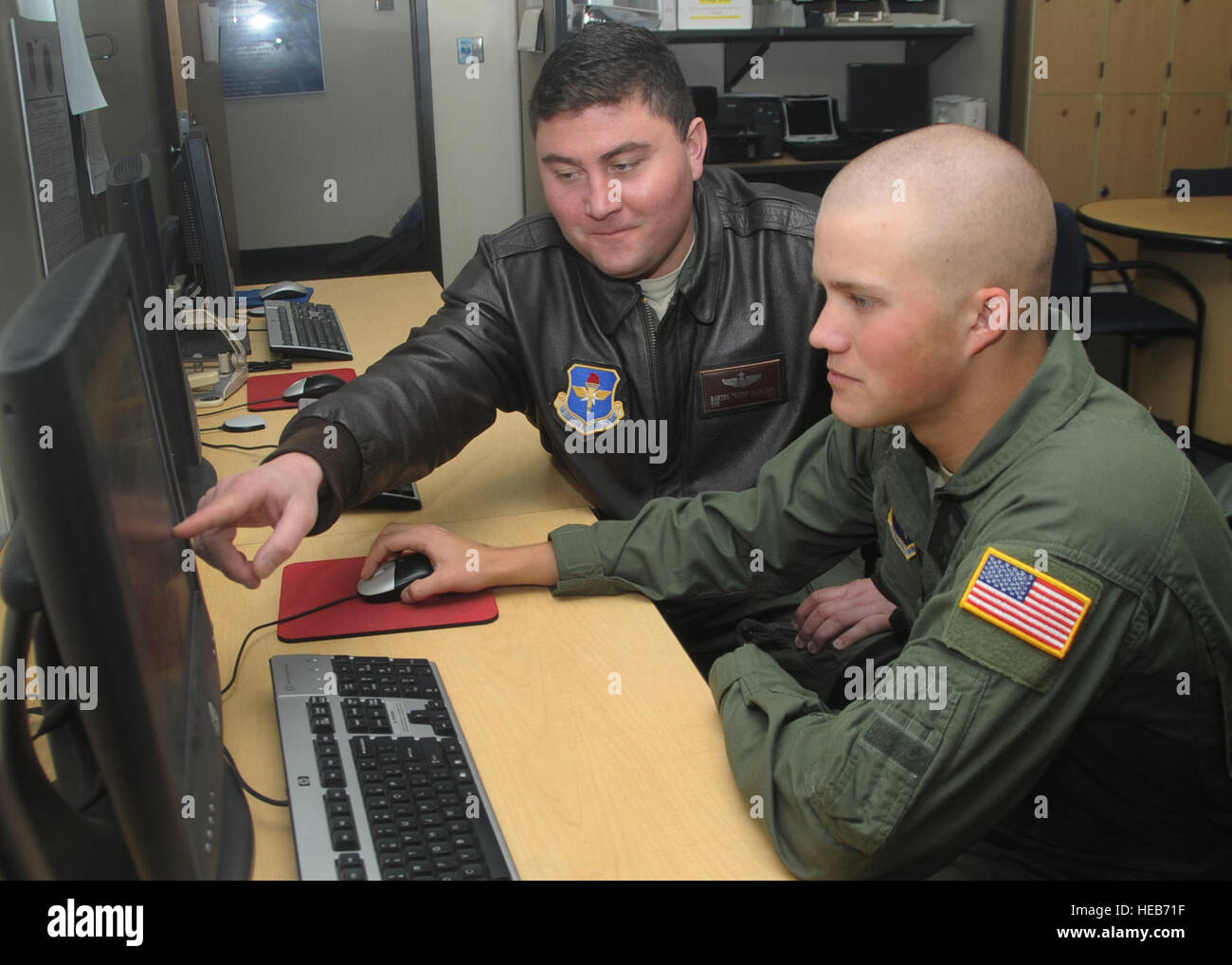 Instructor trains a boom operator trainee in computer navigation as ...