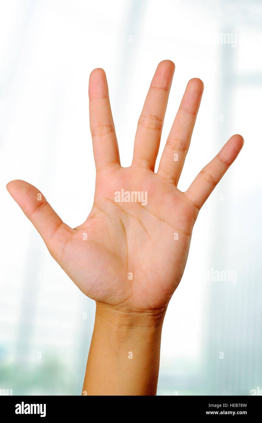 Woman hand gesture with blurry office background Stock Photo - Alamy