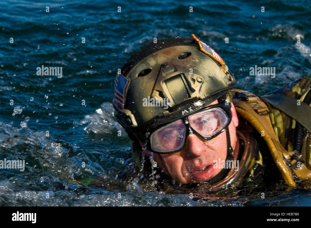 A U.S. Air Force pararescueman, 58th Rescue Squadron, swims toward a ...