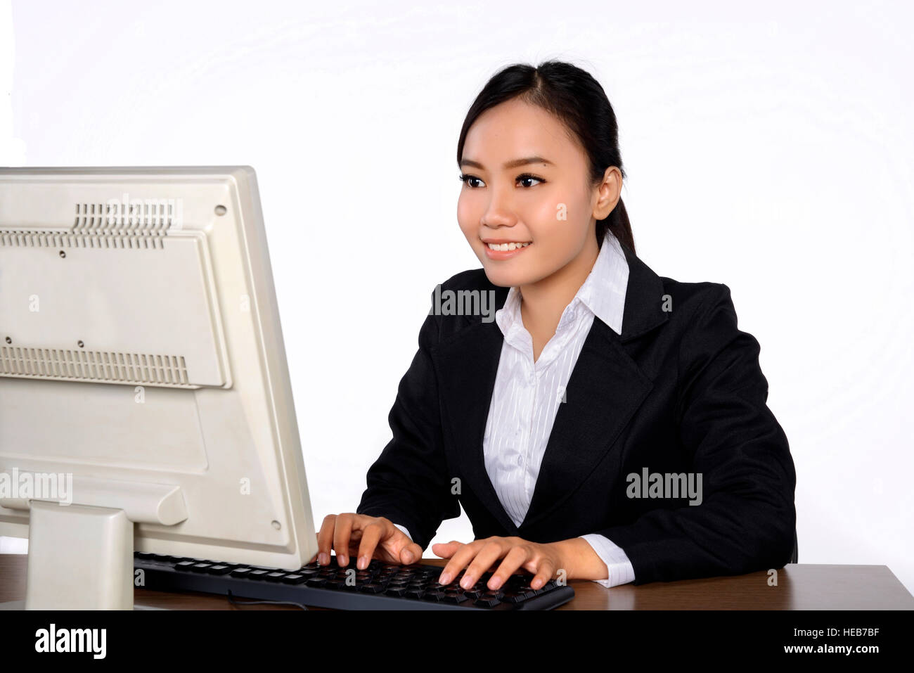 Successful business woman with computer isolated over a white ...