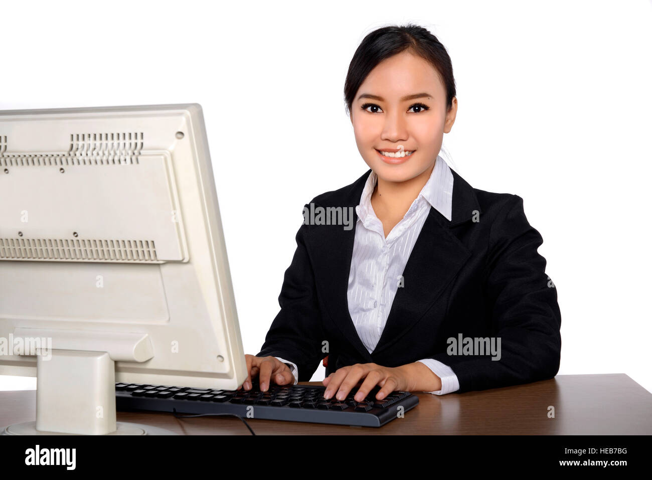 Successful business woman with computer isolated over a white ...