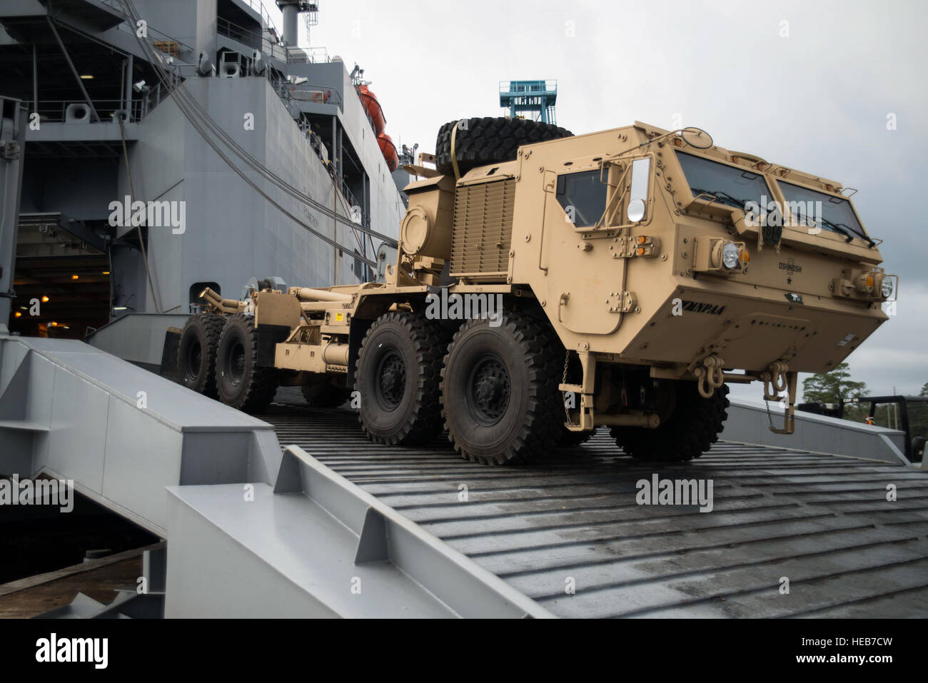 A Mine-Resistant Ambush Protected vehicle is offloaded from the USNS ...